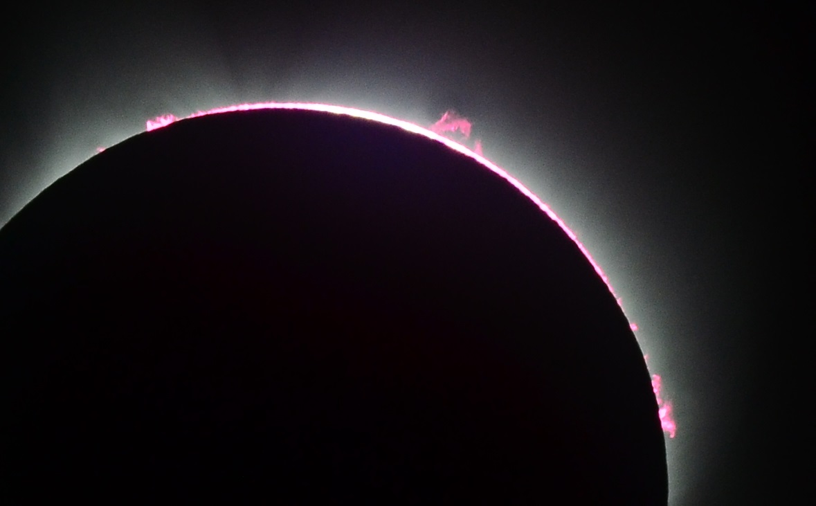 Solar prominences on limb of sun at end of totality - Sky & Telescope