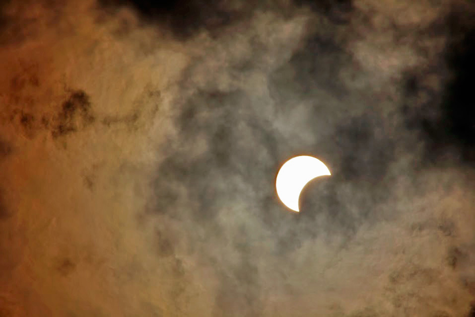 Partial solar eclipse over cloudy sky of Montreal - Sky & Telescope ...