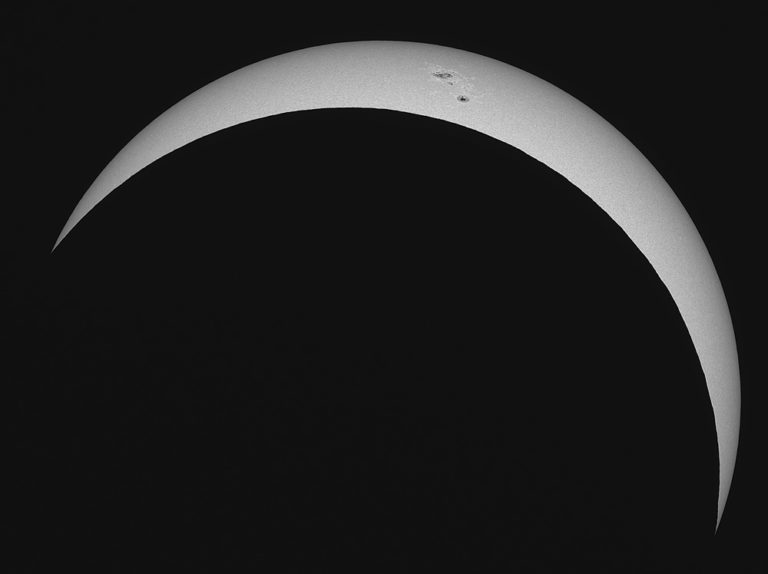 Moon and sunspots just before totality - Sky & Telescope